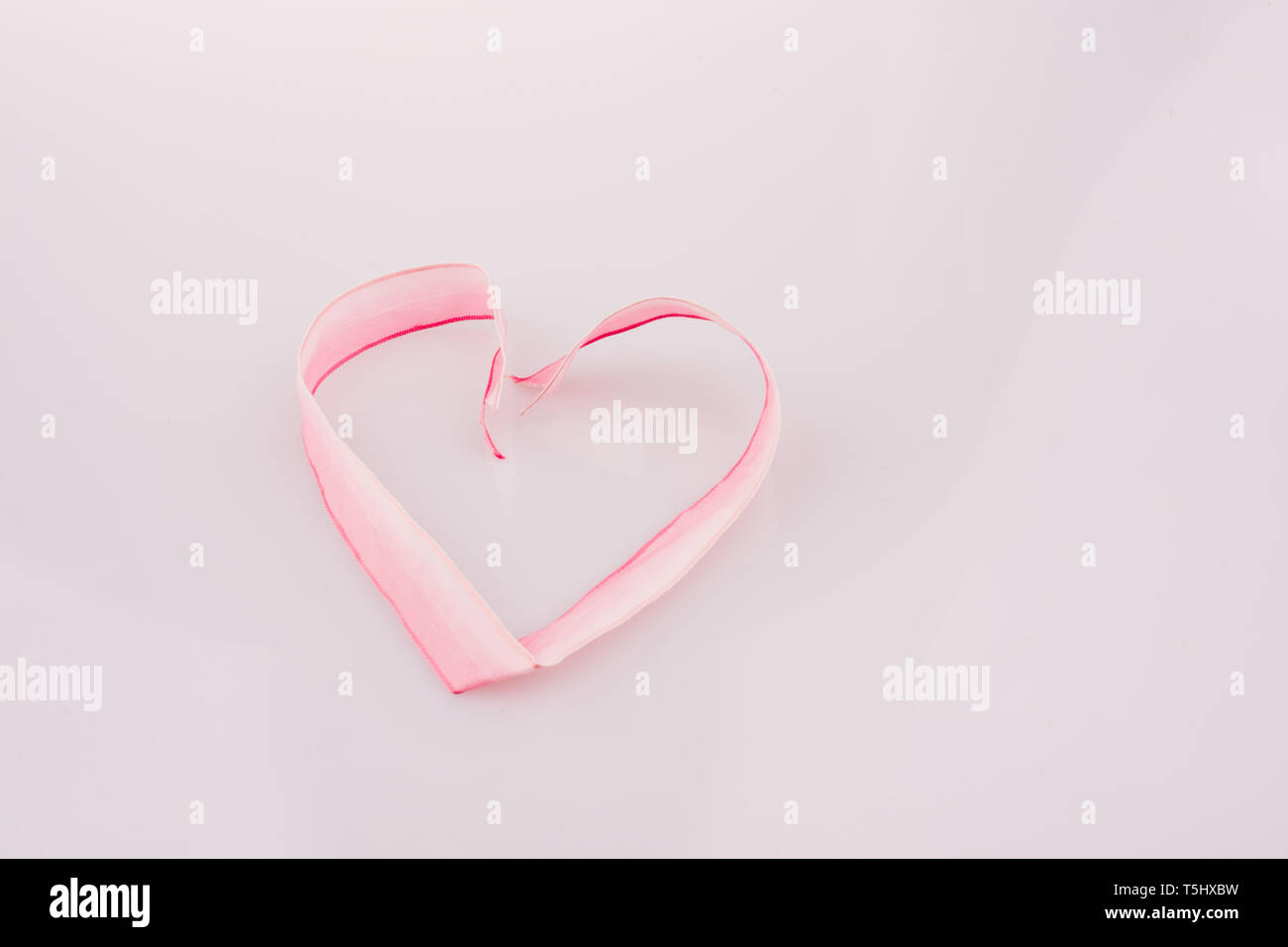 Heart made of ribbon on a white background Stock Photo - Alamy