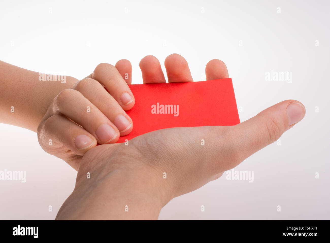 hand holding a red note paper on white background Stock Photo - Alamy