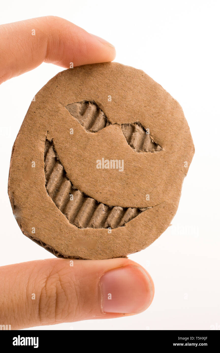 Hand holding a cardboard paper with smiley face Stock Photo - Alamy