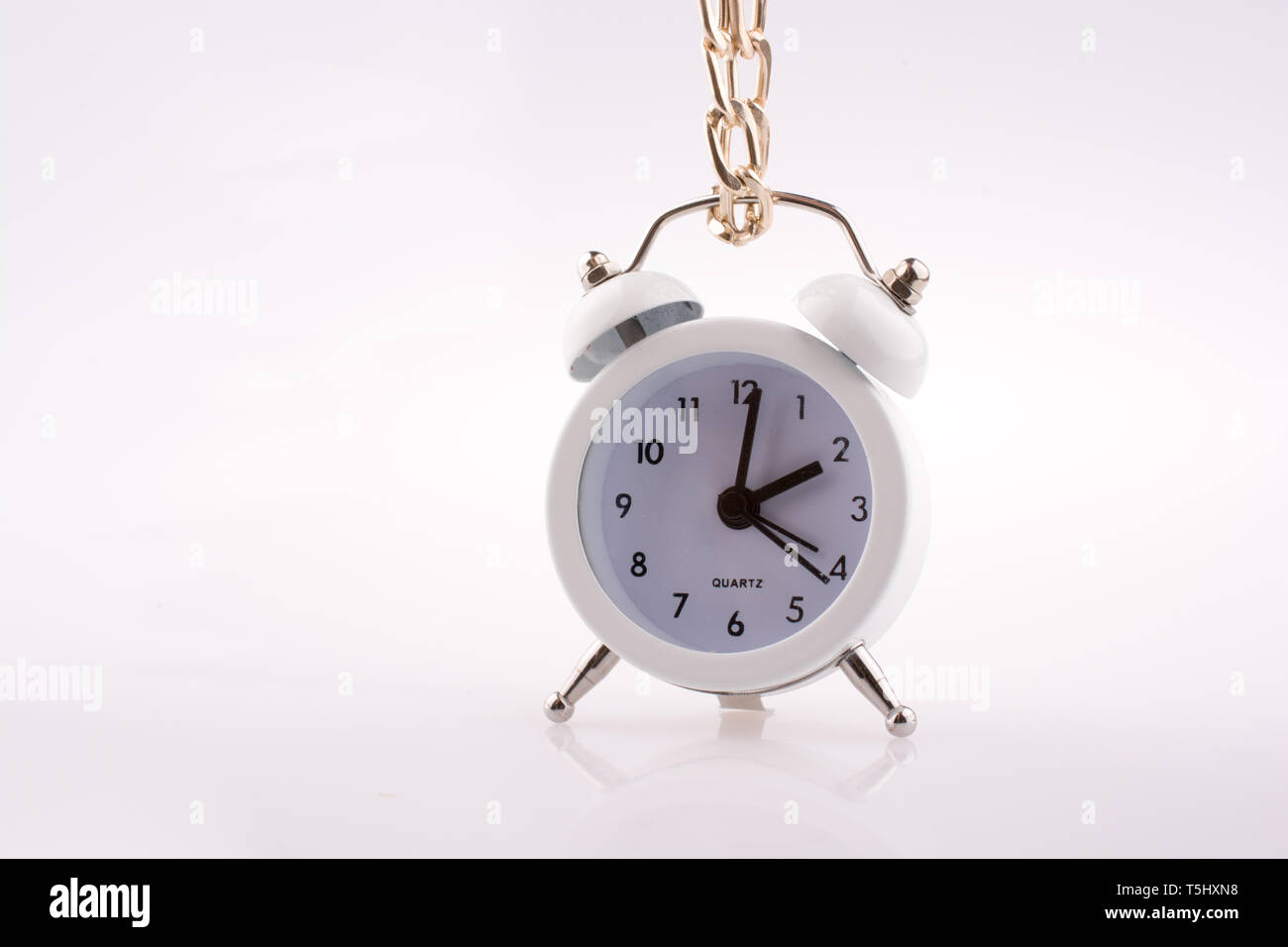 White color alarm clock on white background Stock Photo - Alamy