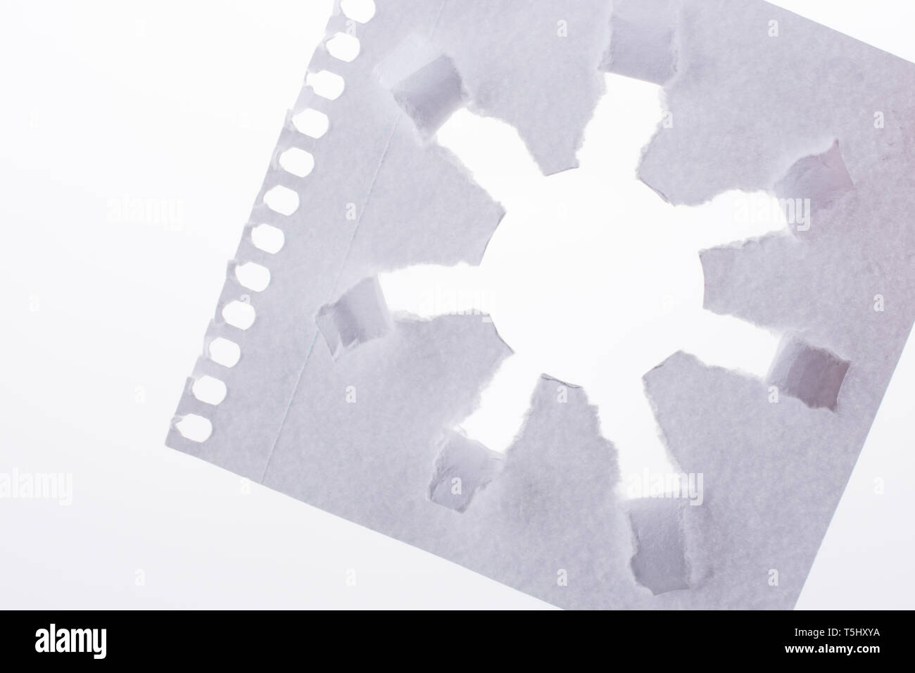 Sun shape made through torn paper in white background Stock Photo - Alamy