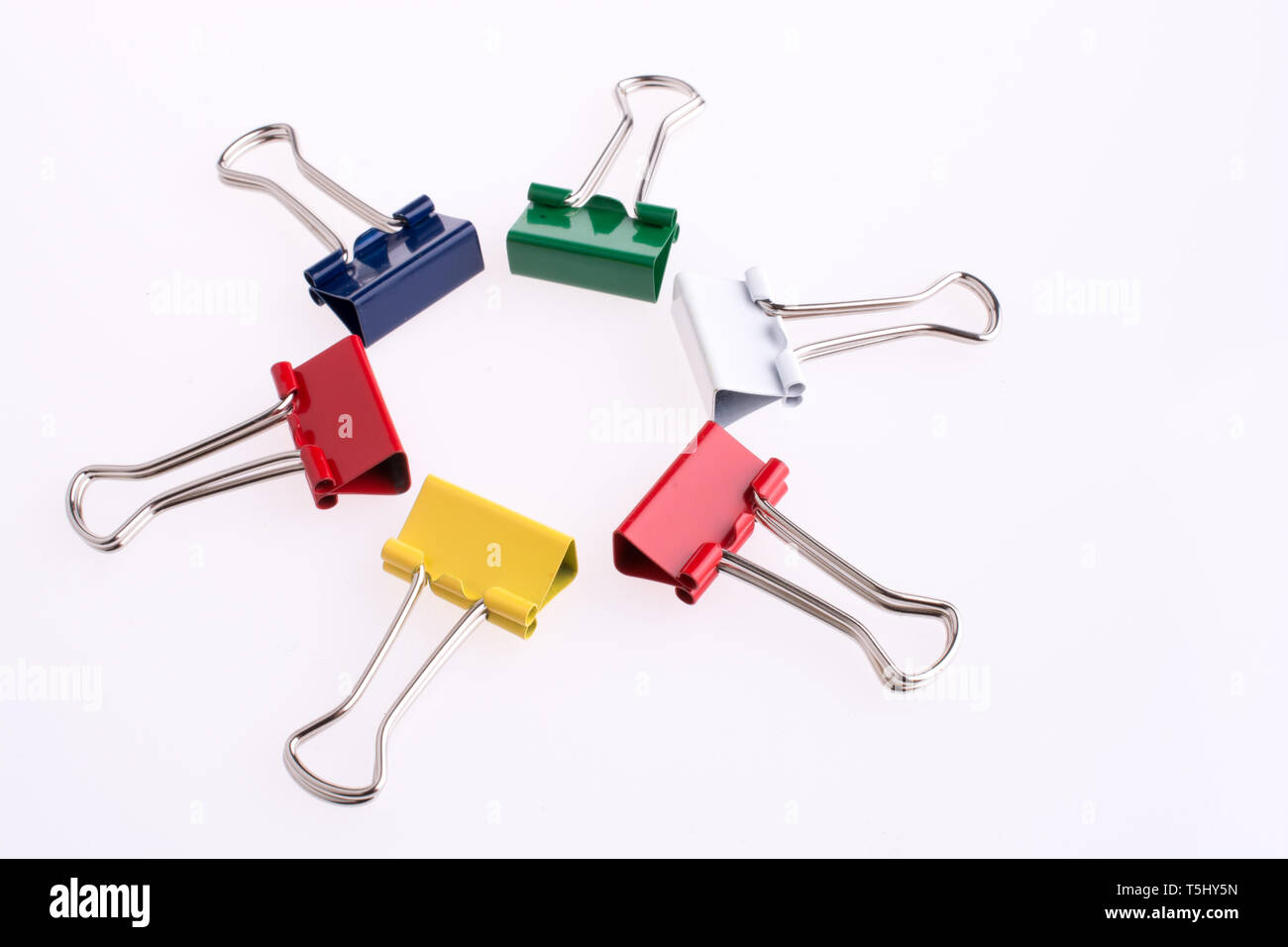 Colored paper clips on a white background Stock Photo - Alamy