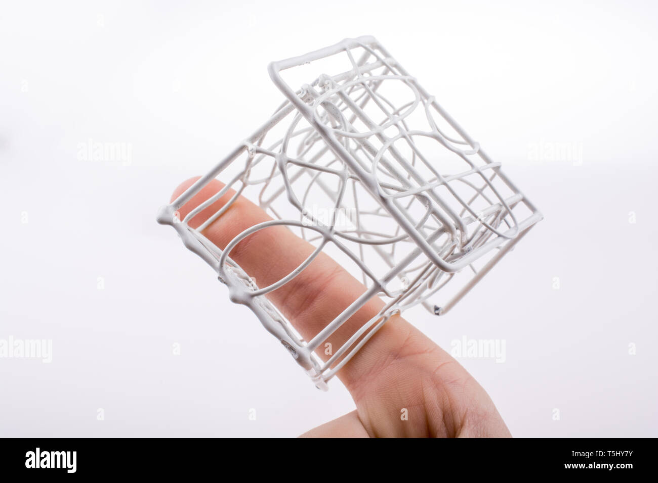 Little model house made of white metal wire in hand Stock Photo - Alamy