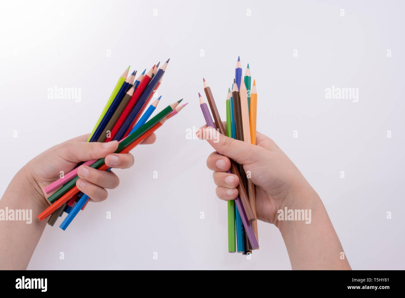 Hand holding color pencils on a white background Stock Photo - Alamy