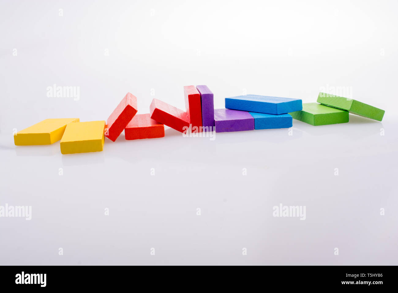 Colorful Domino Blocks in a line on a white background Stock Photo - Alamy