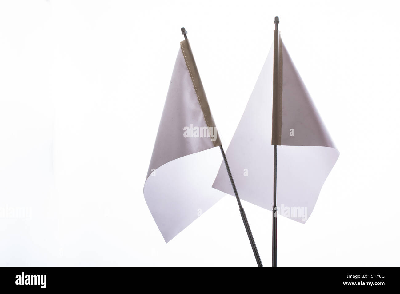Two white flags on a white background in the display Stock Photo - Alamy