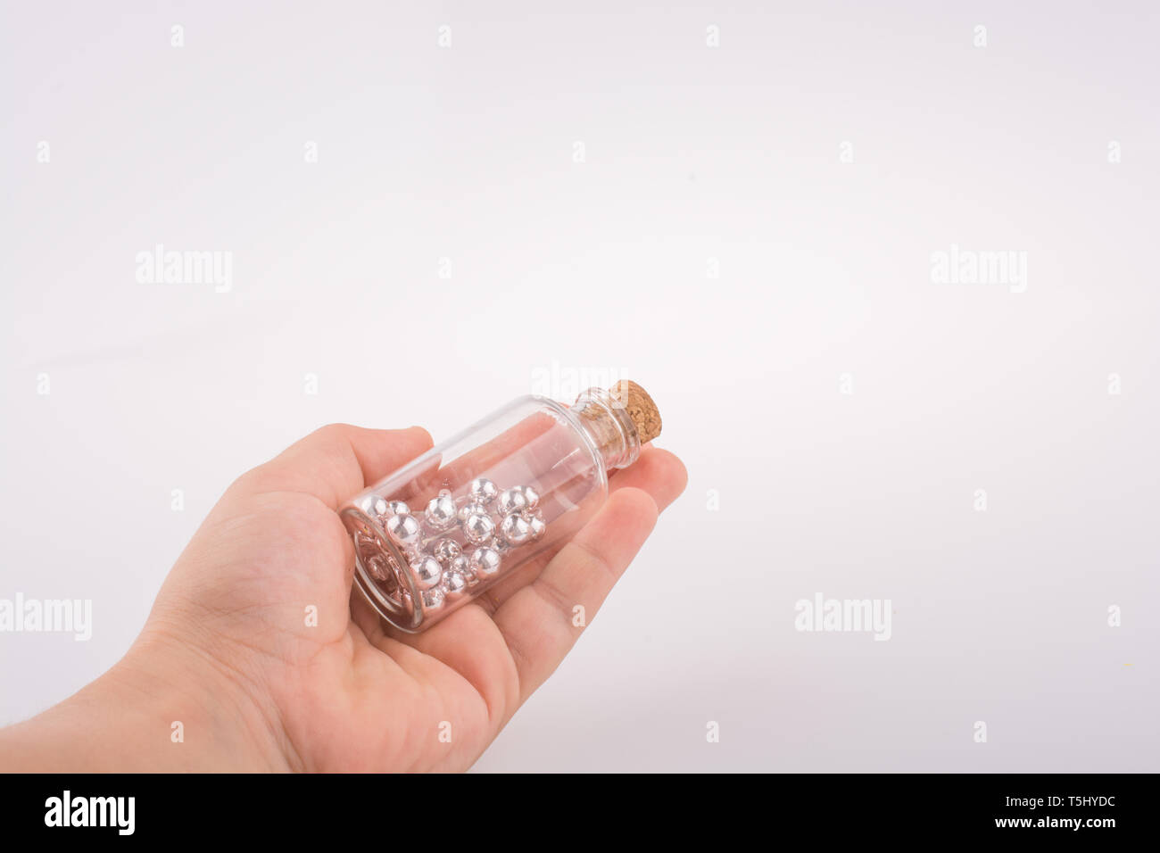 Little perfume glass bottle in hand on a white background Stock Photo ...