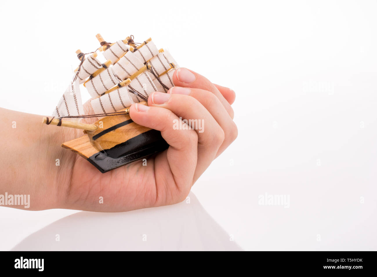 Hand holding a Little model sailboat on a white background Stock Photo ...