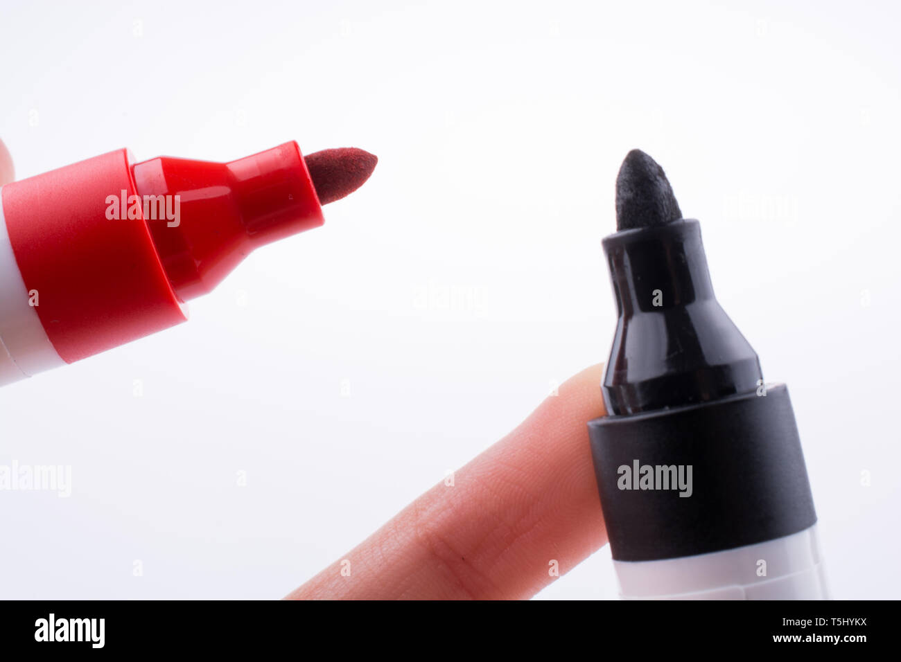 Hand holding Color markers face to face on a white background Stock ...
