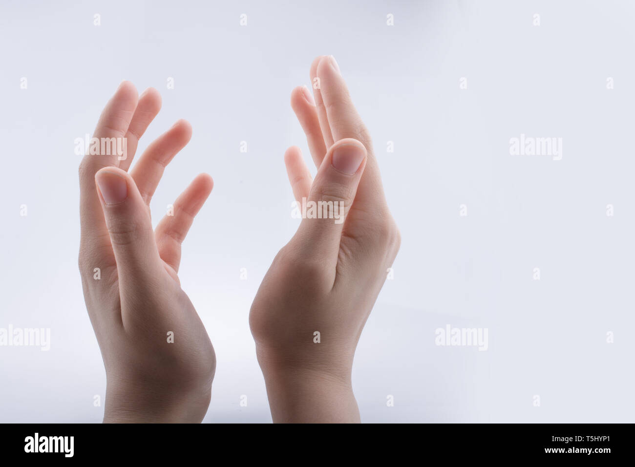 Hand holding gesture made on a white background Stock Photo - Alamy