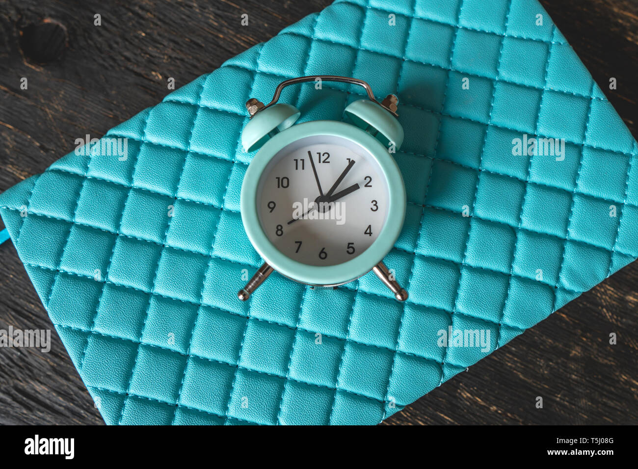 Blue analog metal alarm clock on stylish blue background. The concept ...