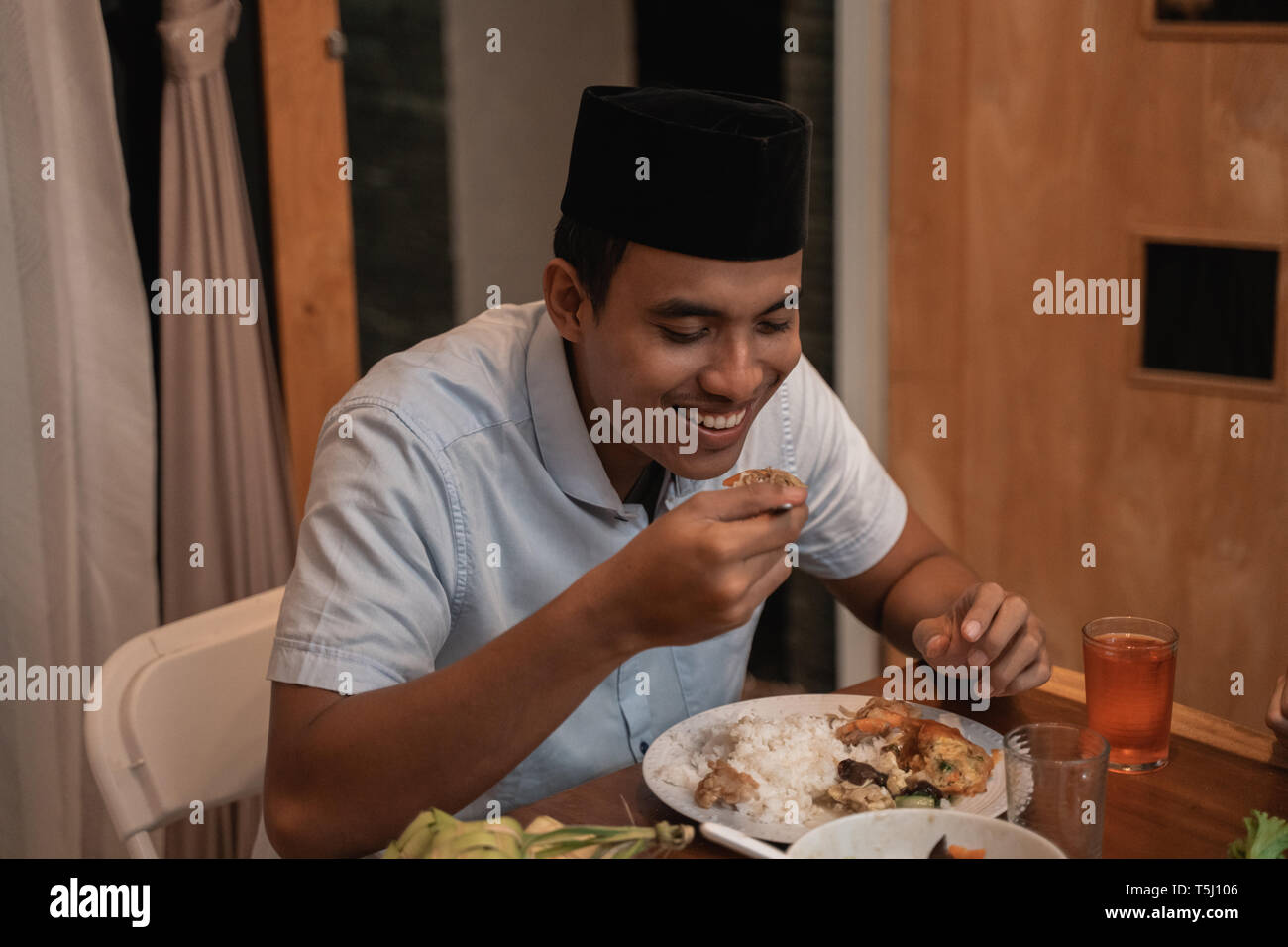 young muslim man eating dinner with family Stock Photo - Alamy