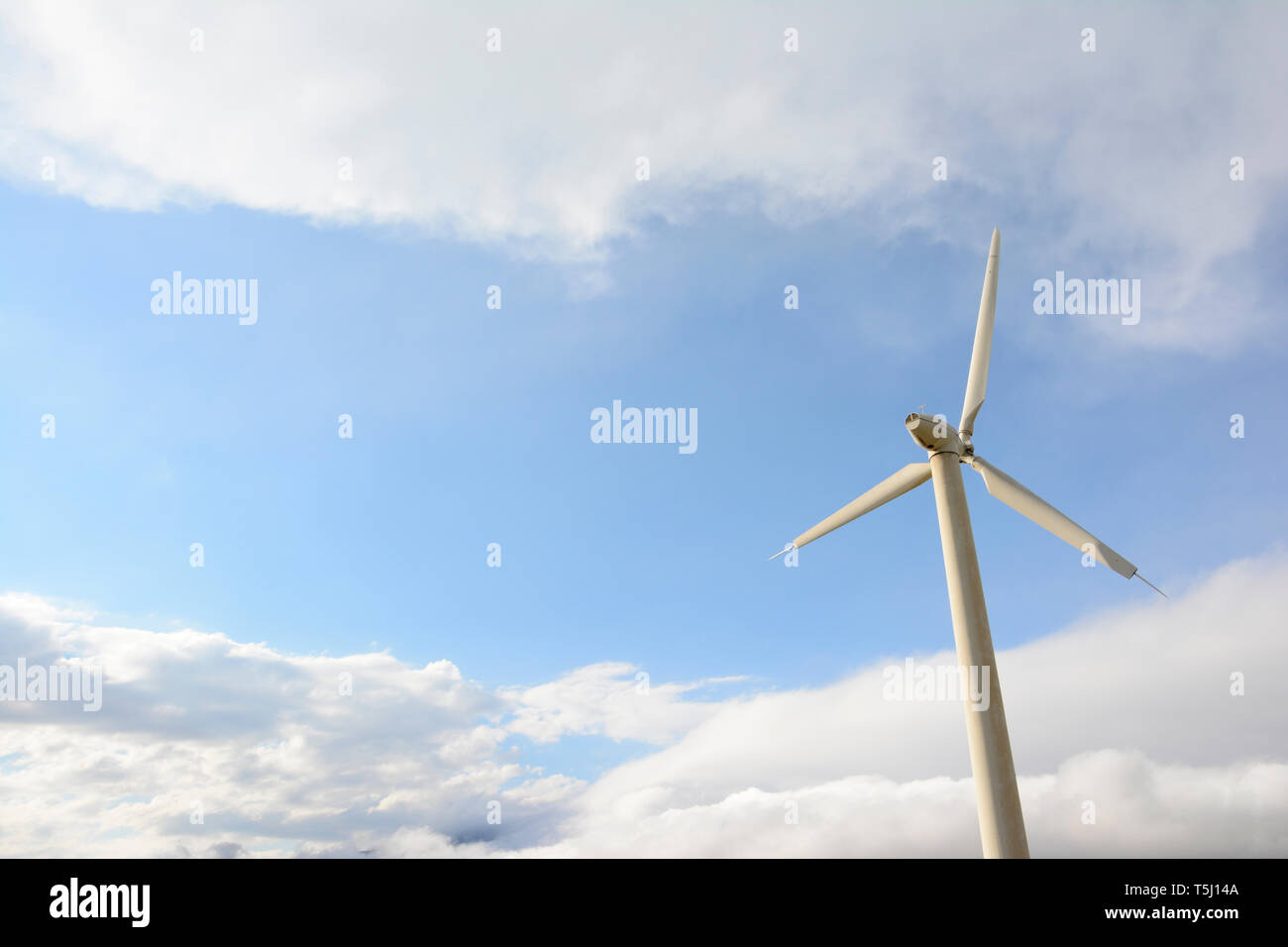 Single windmill in front of cloudy sky, environmentally friendly ...