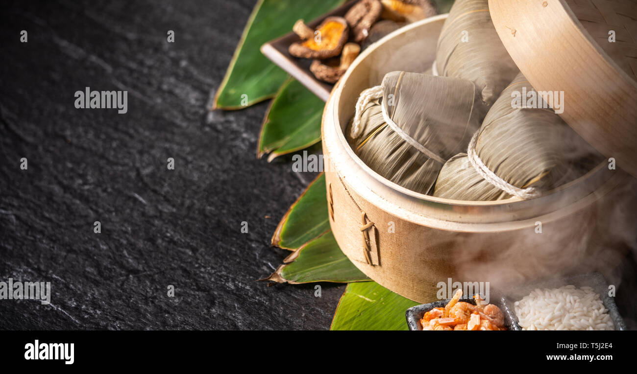 Zongzi, delicious fresh hot steamed rice dumplings in steamer. Close up ...