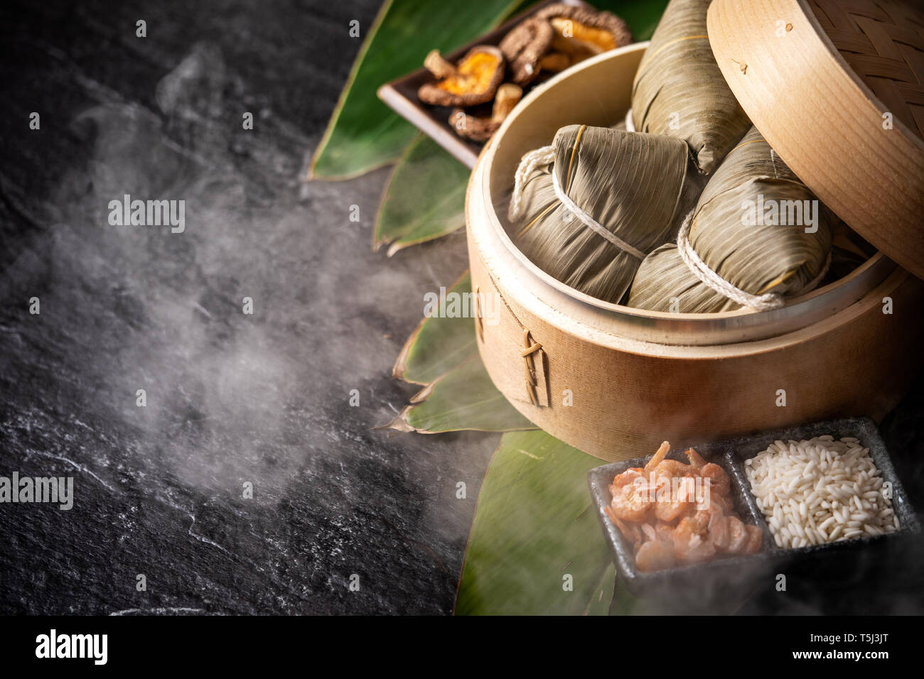 Zongzi, delicious fresh hot steamed rice dumplings in steamer. Close up ...