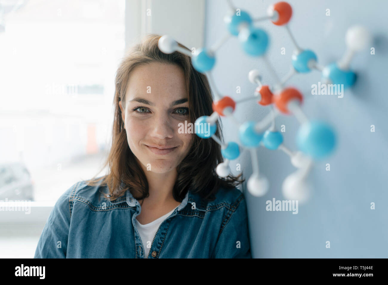 Female scientist studying molecule model, looking for solutions Stock ...