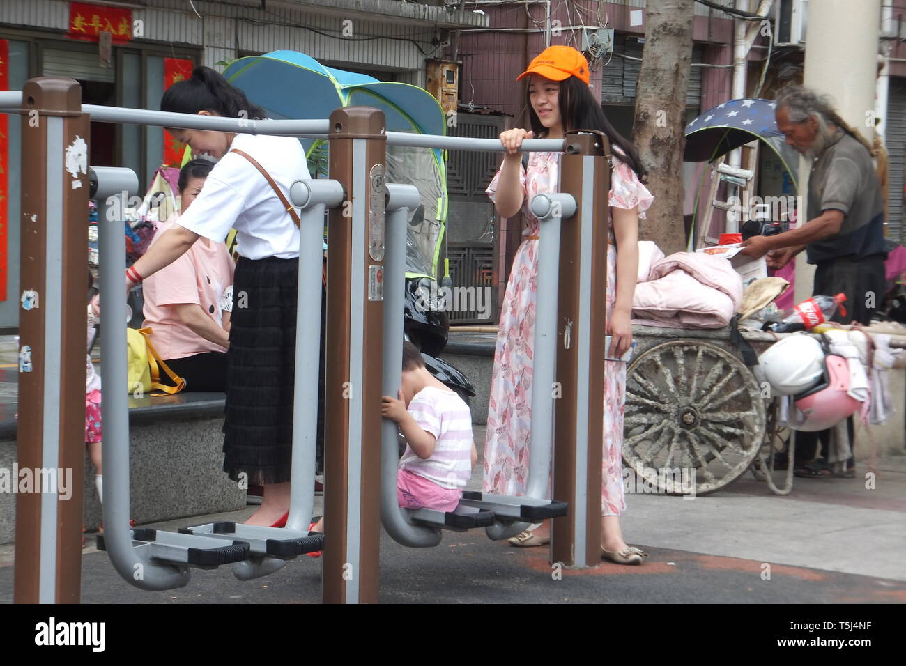 Shenzhen, China: young mothers play outdoors with their young children ...