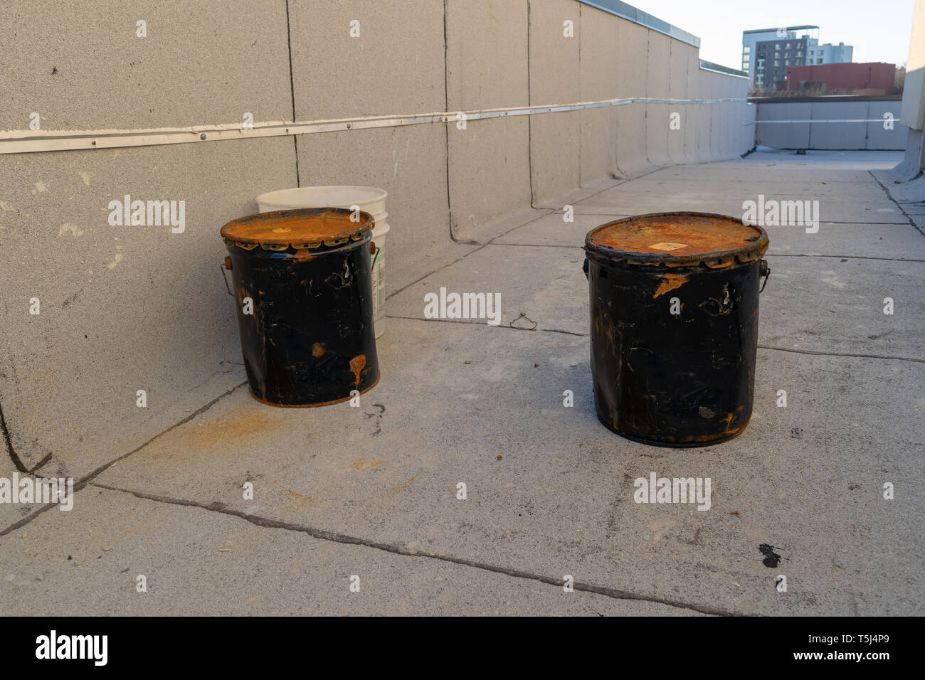 Old rusty dented metal buckets, on a New York City rooftop, Bronx, NY ...
