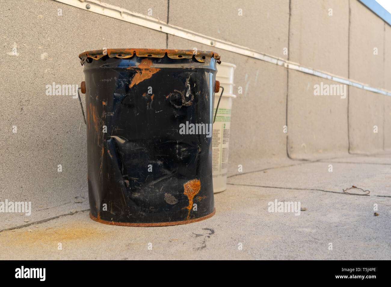Old, black metal bucket, dented and rusty, close-up Stock Photo - Alamy