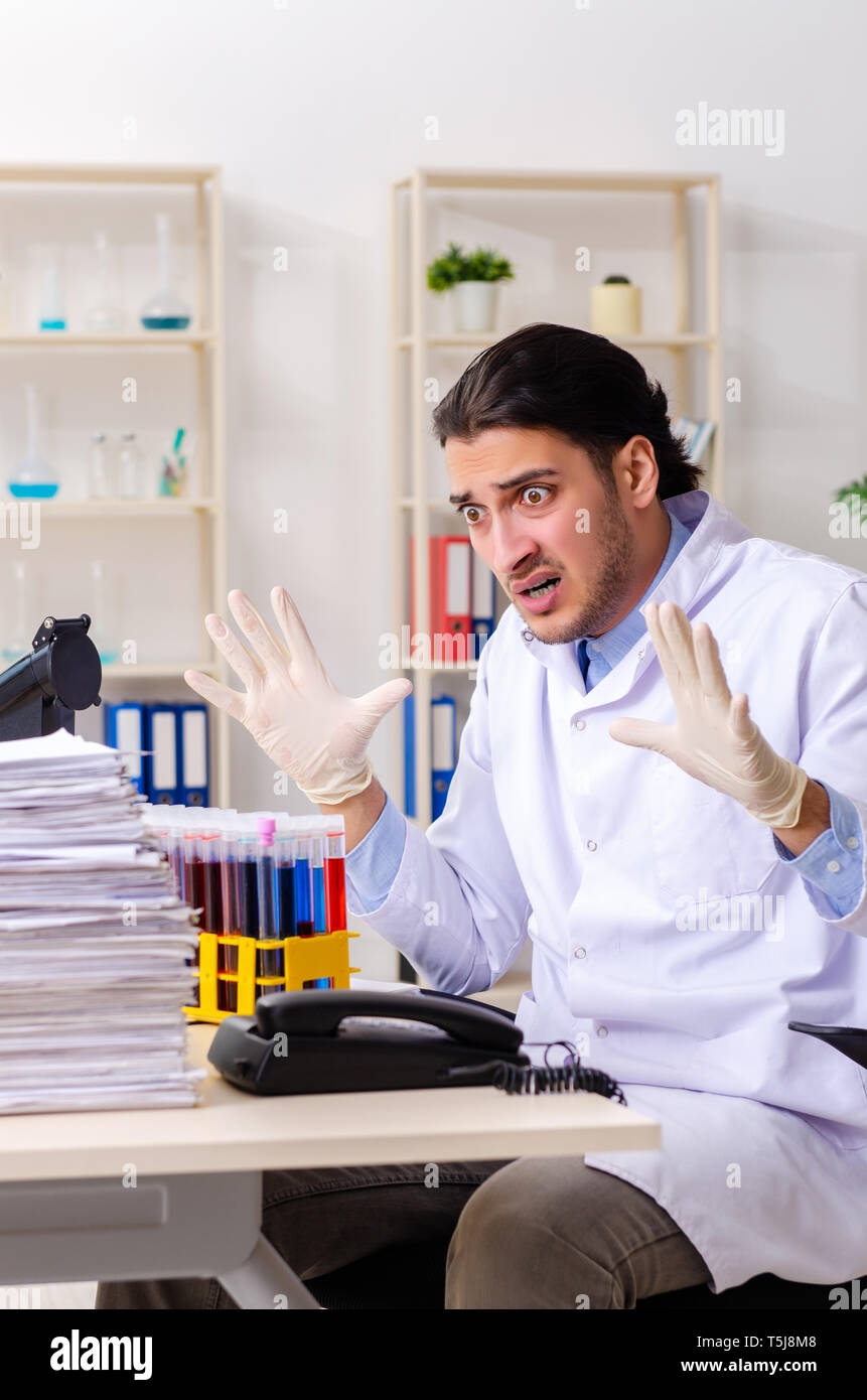 Young male chemist working in the lab Stock Photo - Alamy