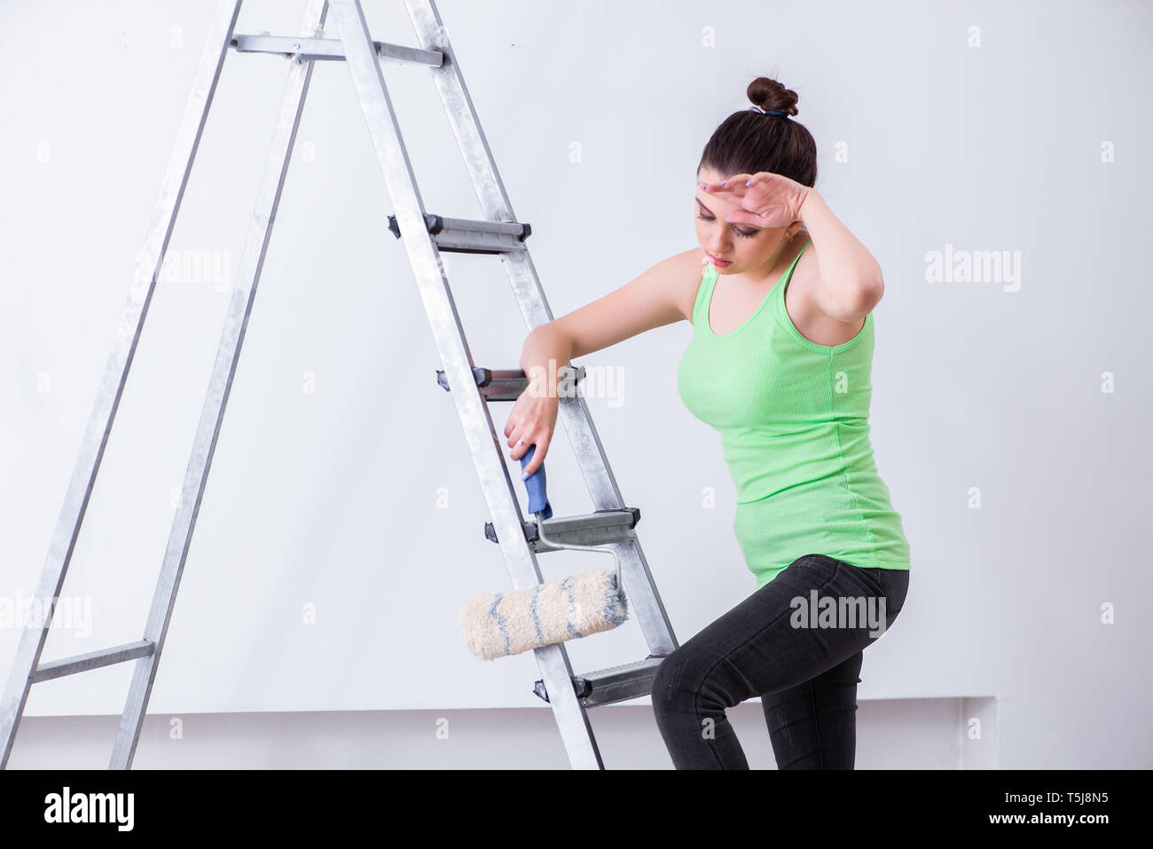 Young beautiful woman doing renovation at home Stock Photo - Alamy