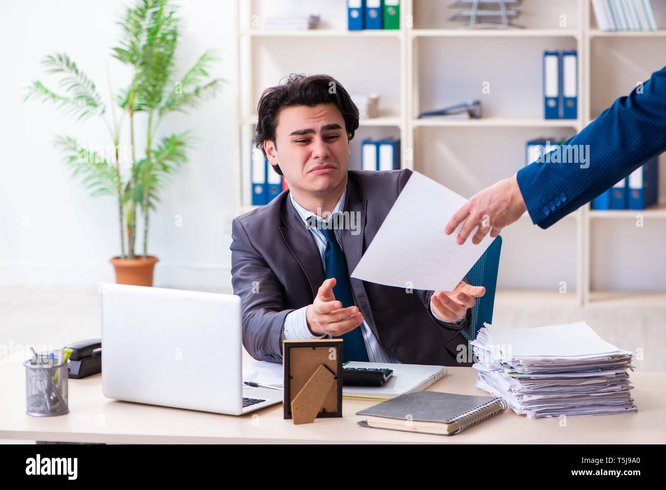 Young male employee being fired from his work Stock Photo - Alamy