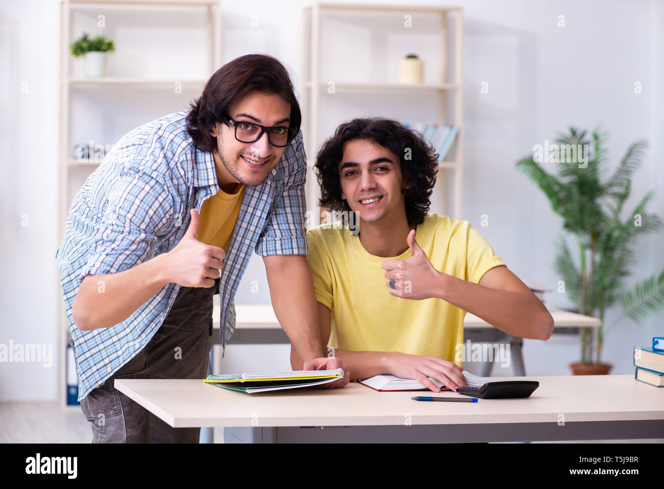 Two male students in the classroom Stock Photo - Alamy