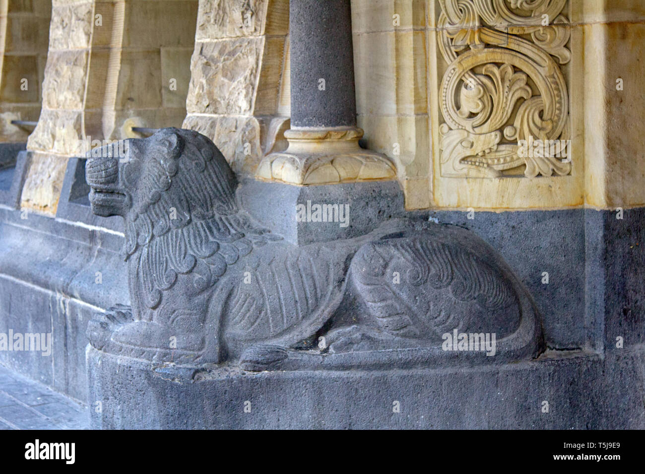 Lion sculpture in the Assyrian-Egyptian style at the base of the ...
