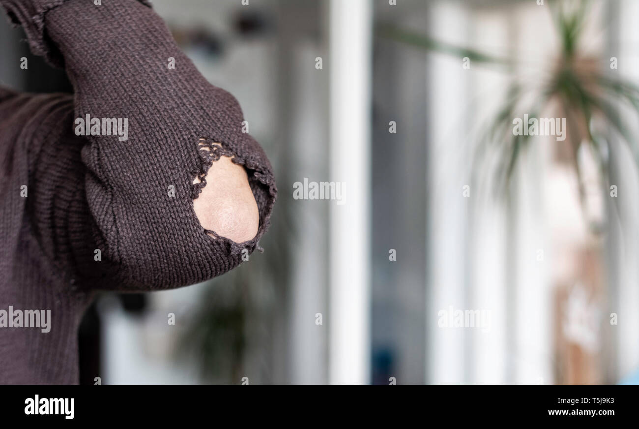 Man with worn to holes fabric sweater with pipped sleeve - Person ...