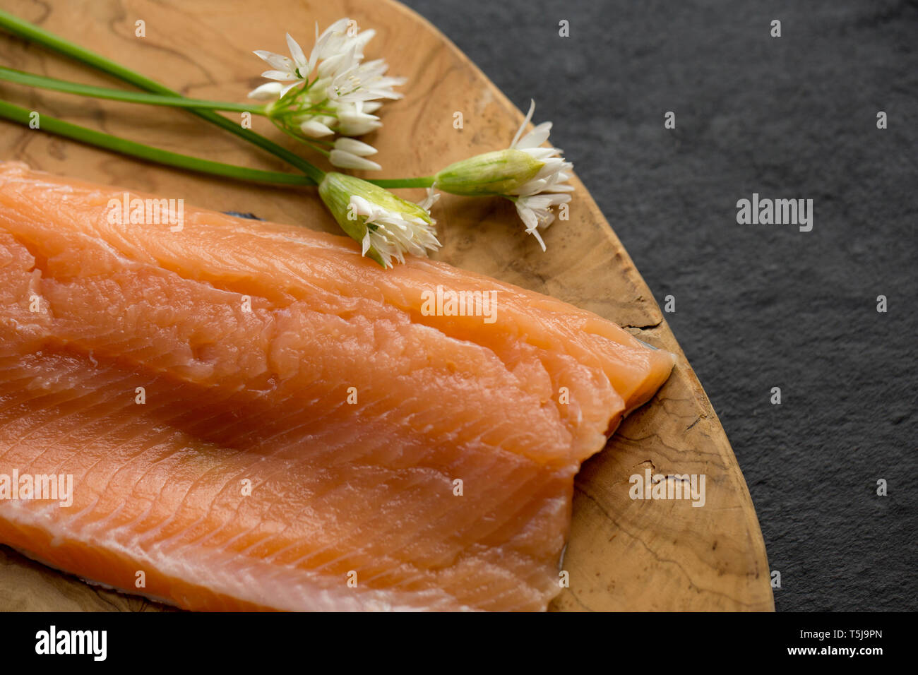 A single, raw fillet from a rainbow trout, Oncorhynchus mykiss, that ...