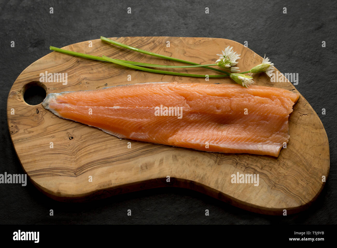 A single, raw fillet from a rainbow trout, Oncorhynchus mykiss, that ...