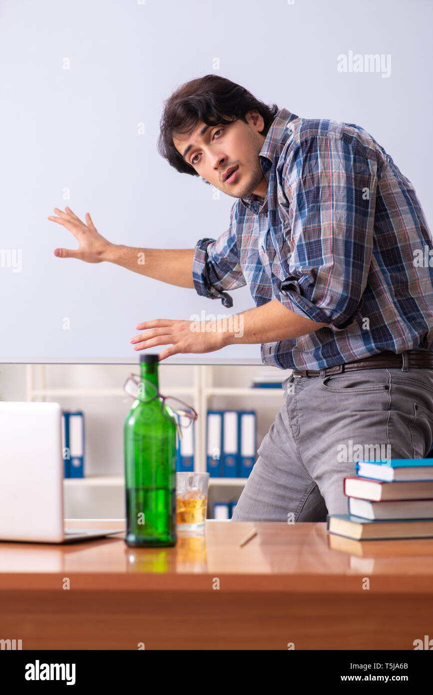Male teacher drinking in the classroom Stock Photo - Alamy