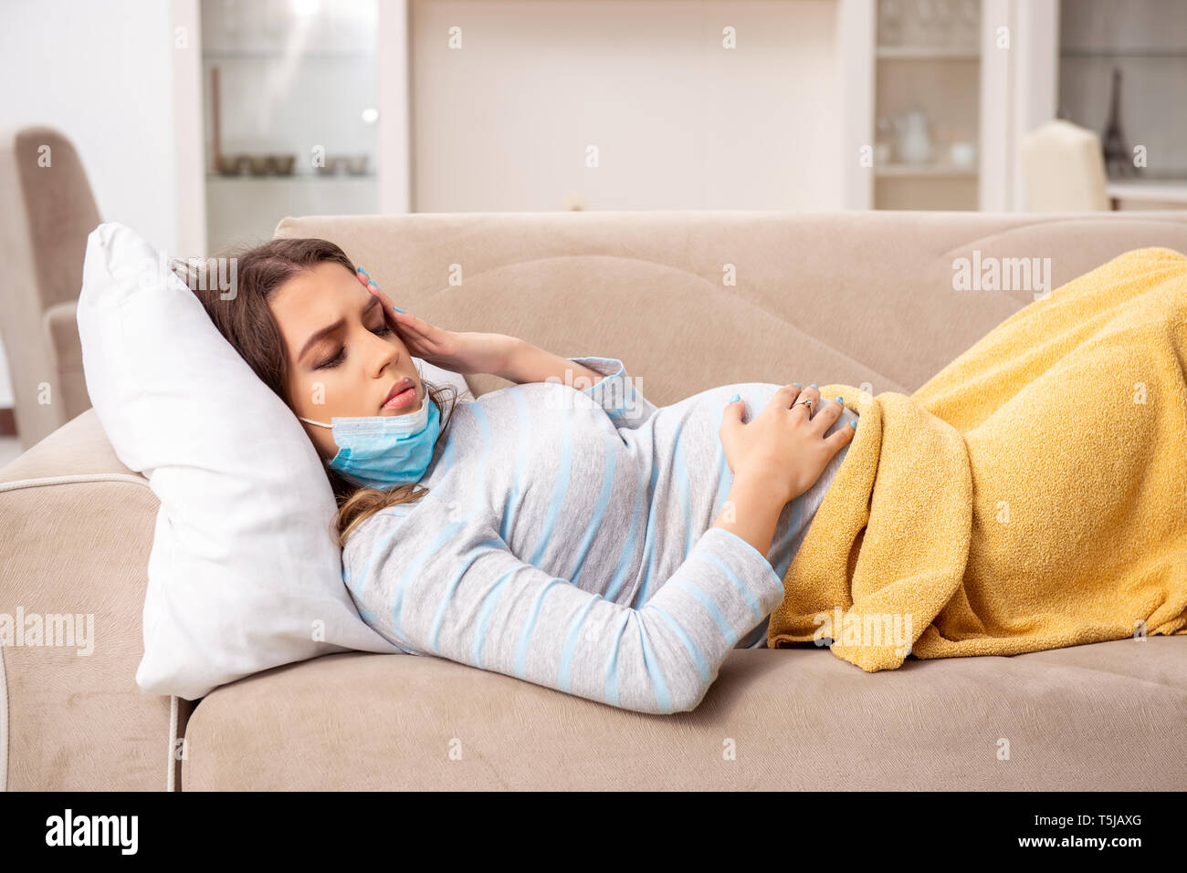 Sick pregnant woman suffering at home Stock Photo - Alamy