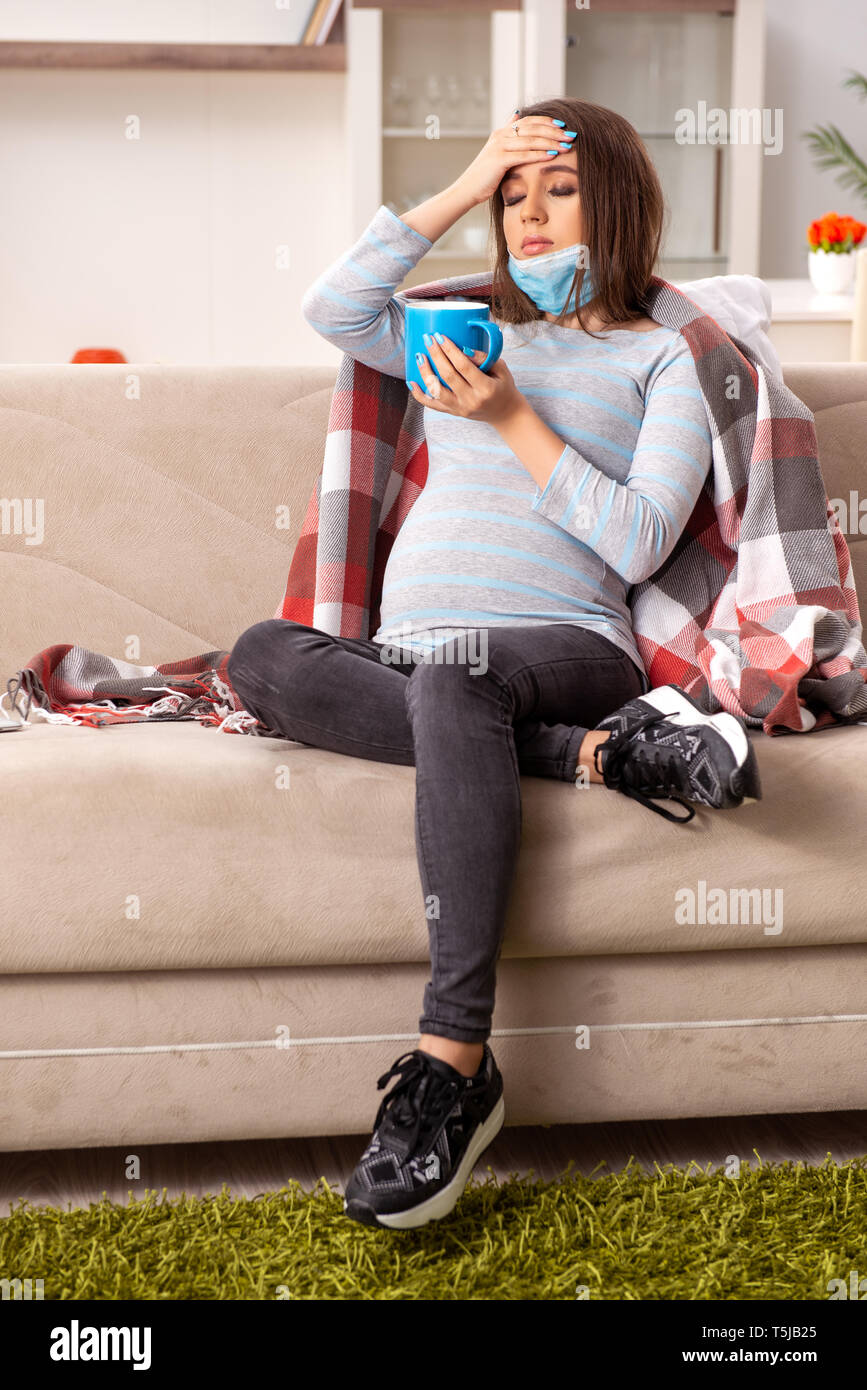 Sick pregnant woman suffering at home Stock Photo - Alamy