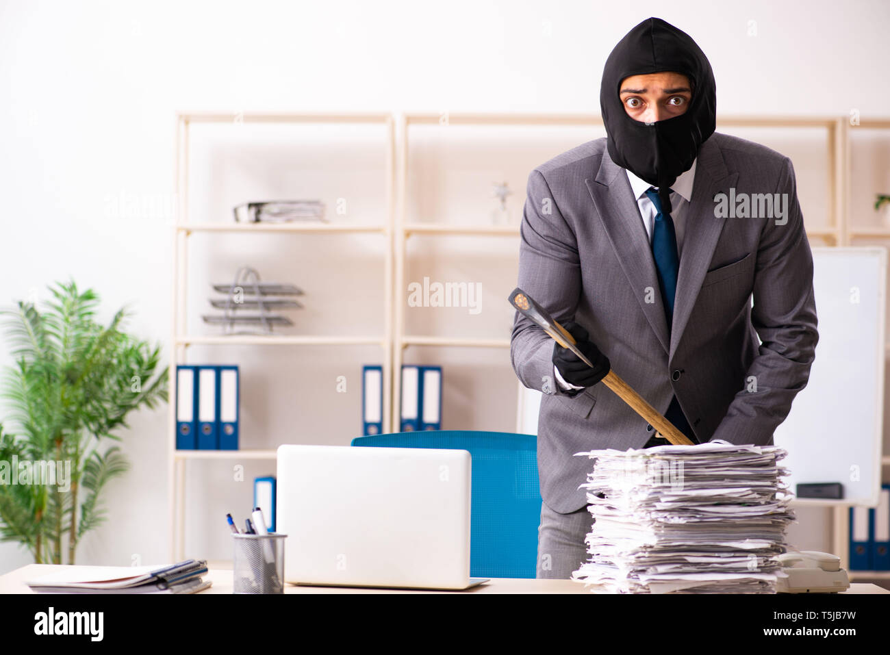 Male gangster stealing information from the office Stock Photo - Alamy