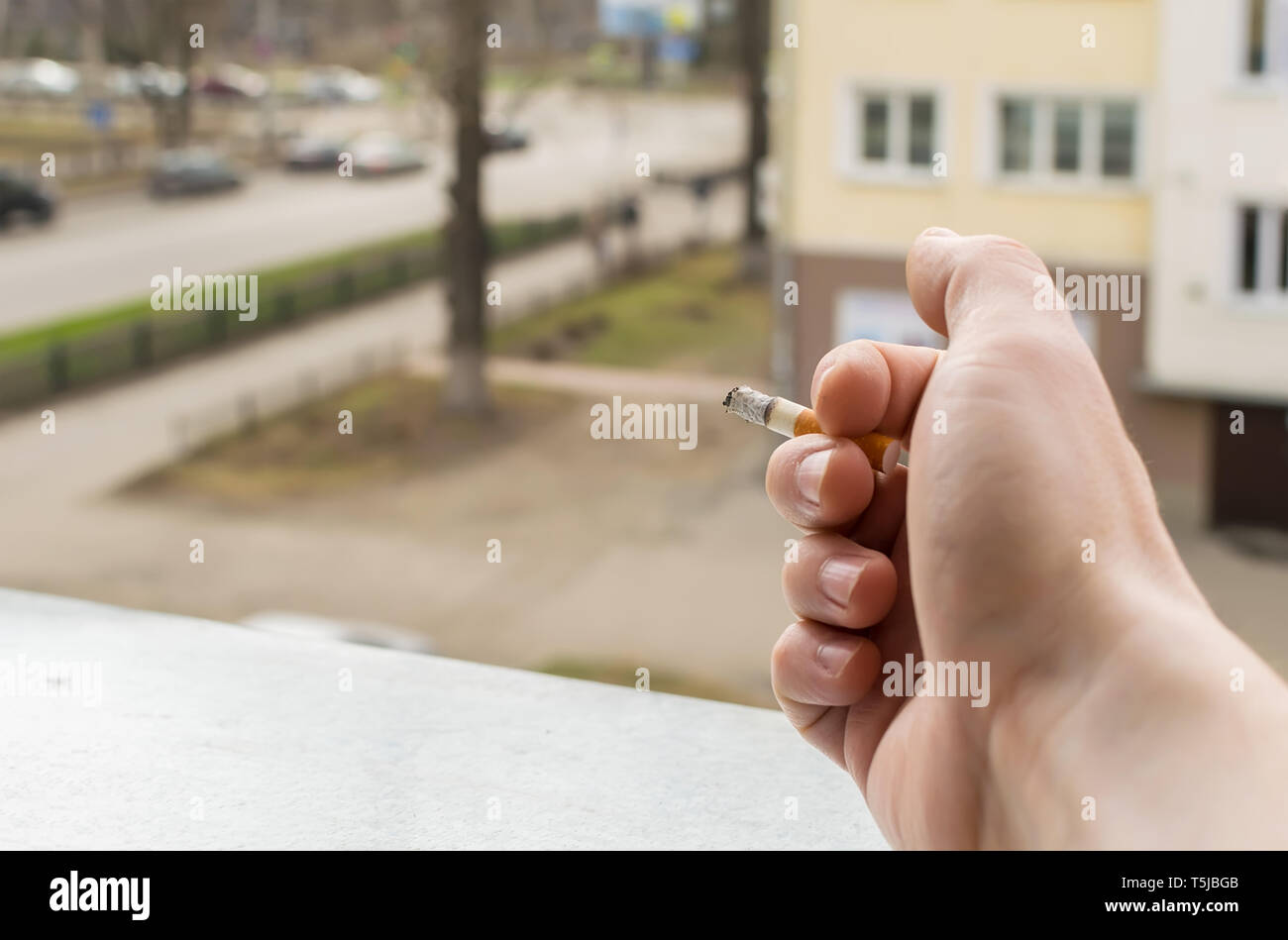 View of the hand of a Smoking man with a Smoking cigarette from the ...