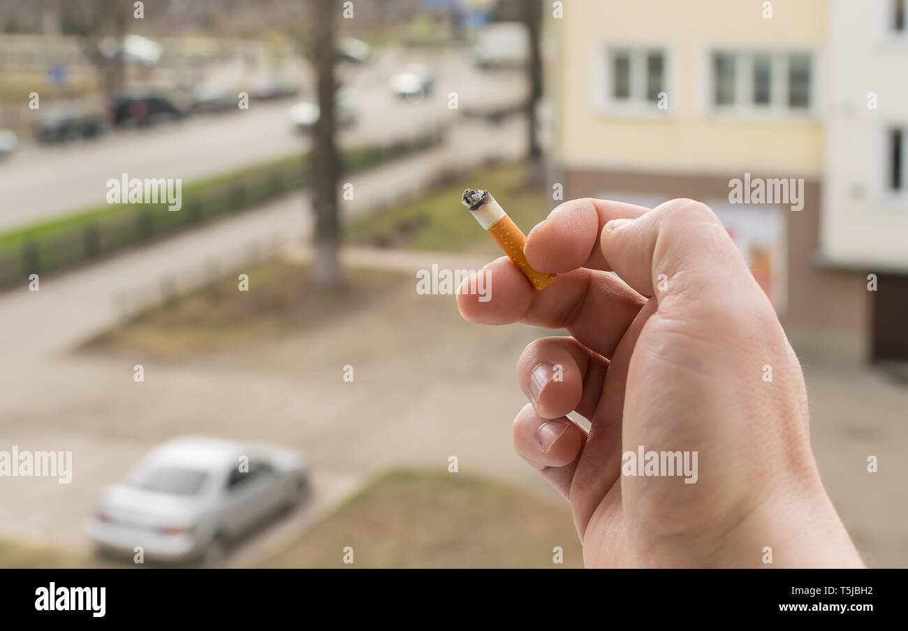 View of the hand of a Smoking man with a Smoking cigarette from the ...