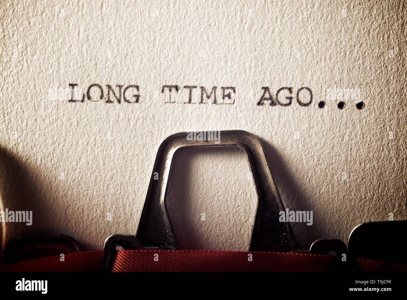 The sentence, long time ago, written with a typewriter Stock Photo - Alamy