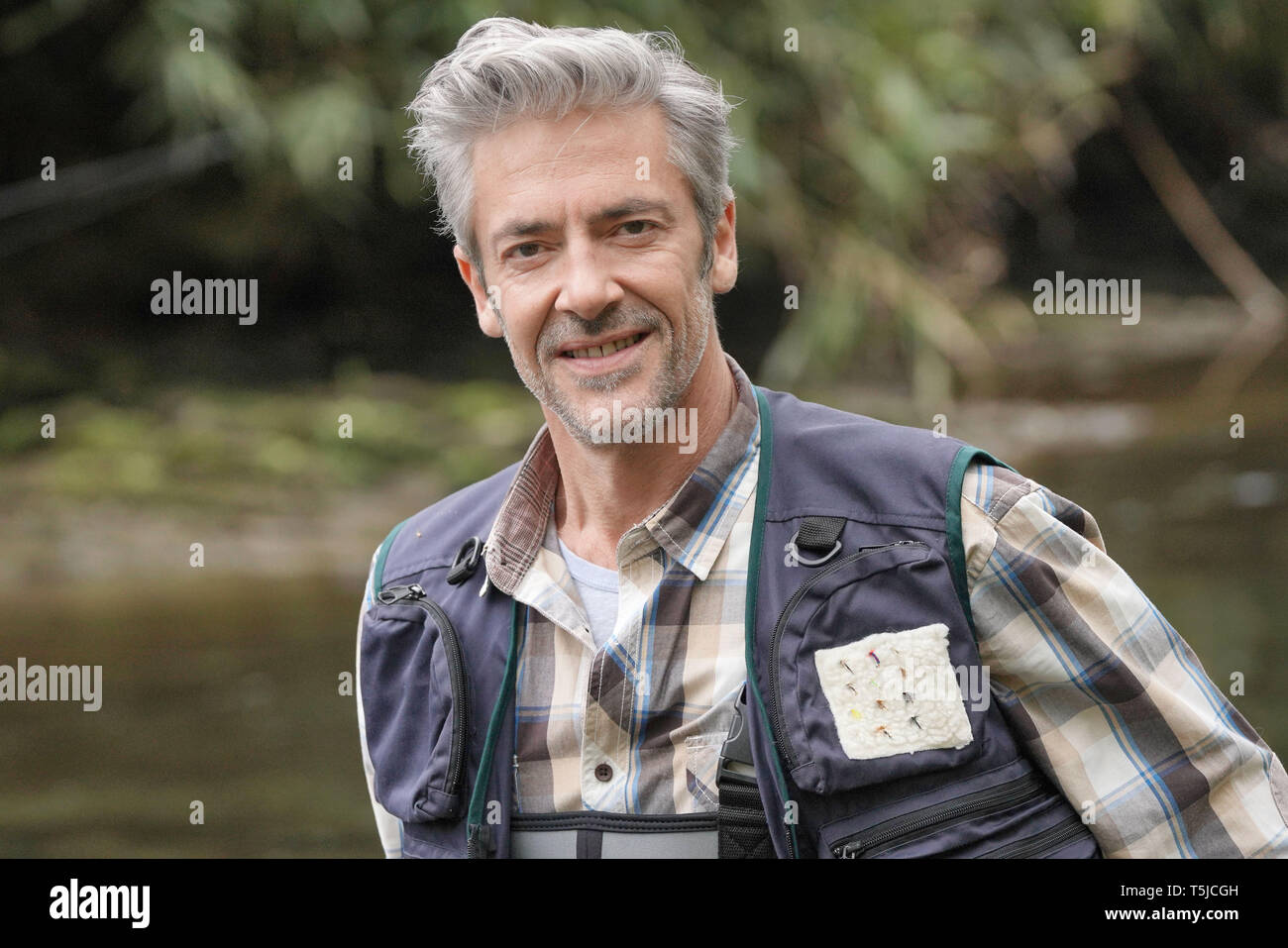 Portrait of fly fisherman smiling at camera Stock Photo - Alamy