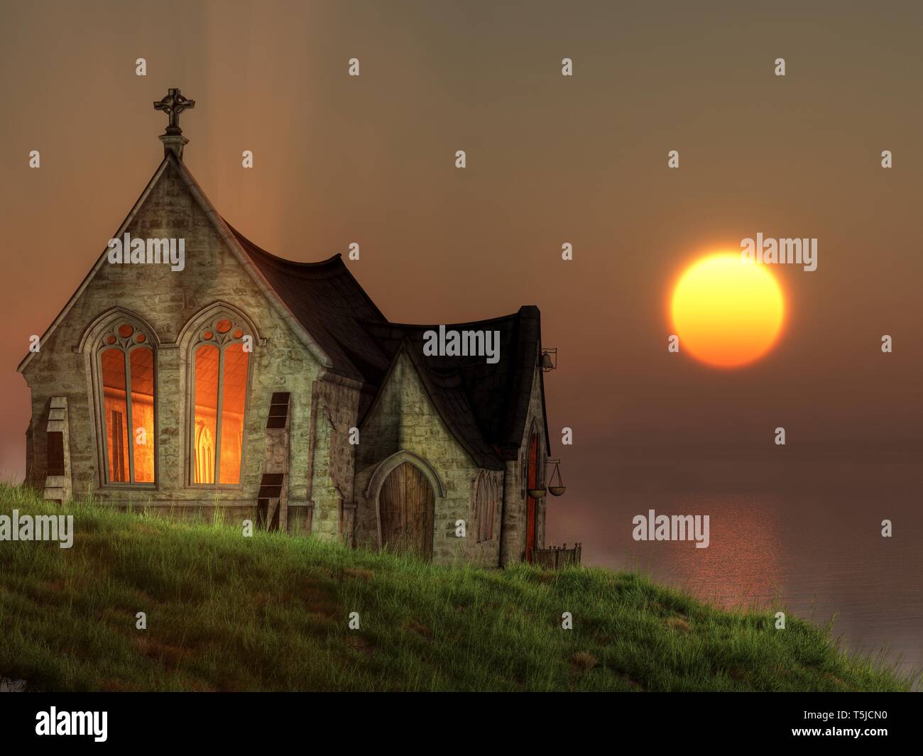 A little church sits on an sea side cliff. Behind it the sun sets over ...
