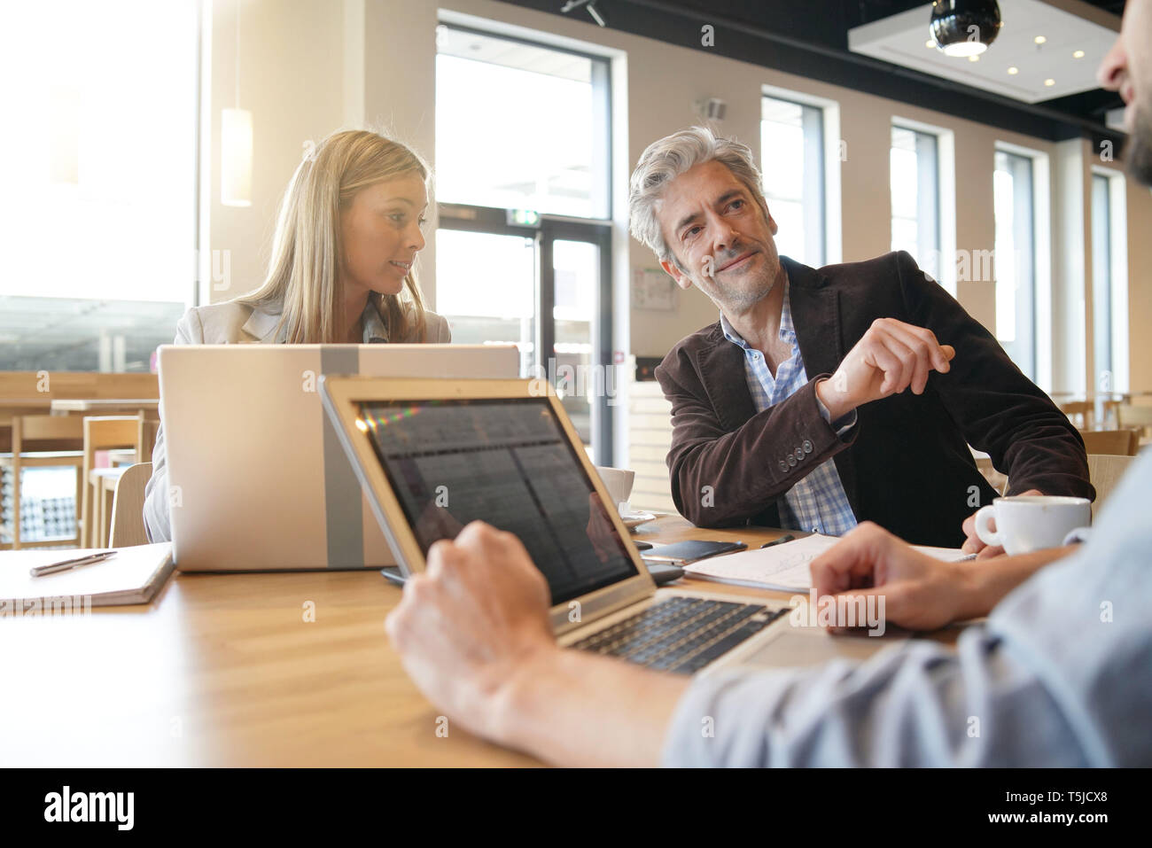 Mixed sales team working through presentation before meeting Stock ...
