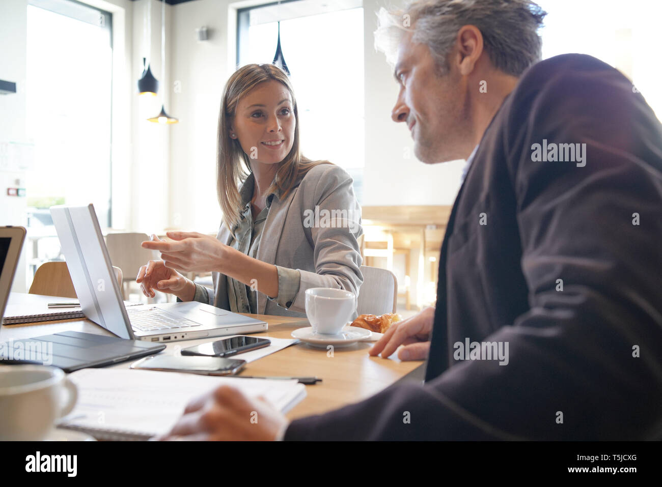 Mixed sales team working through presentation before meeting Stock ...