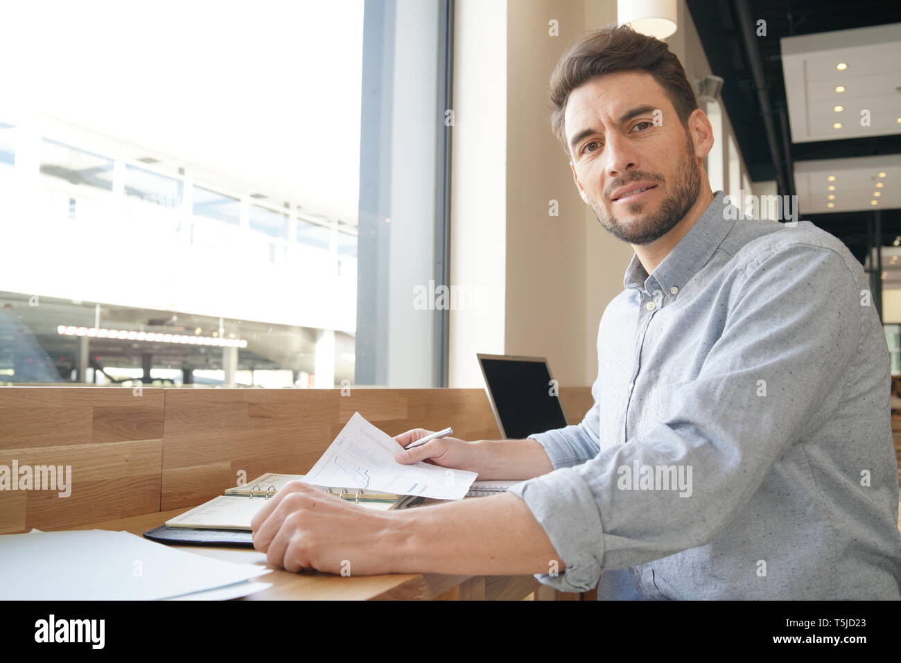 Handsome salesman preparing presentation on work trip Stock Photo - Alamy