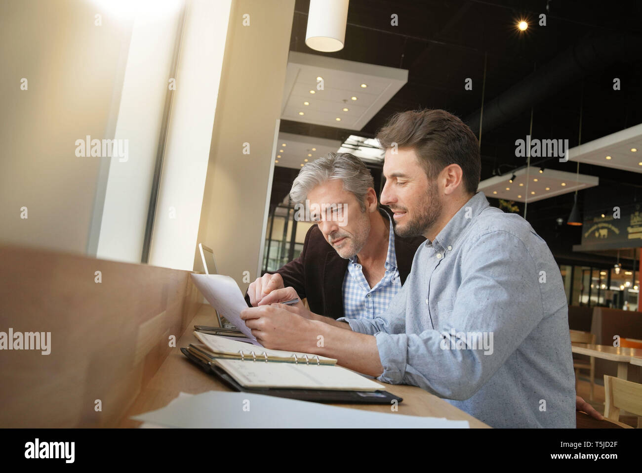 Salesman coworkers going through sales pitch on work trip Stock Photo ...