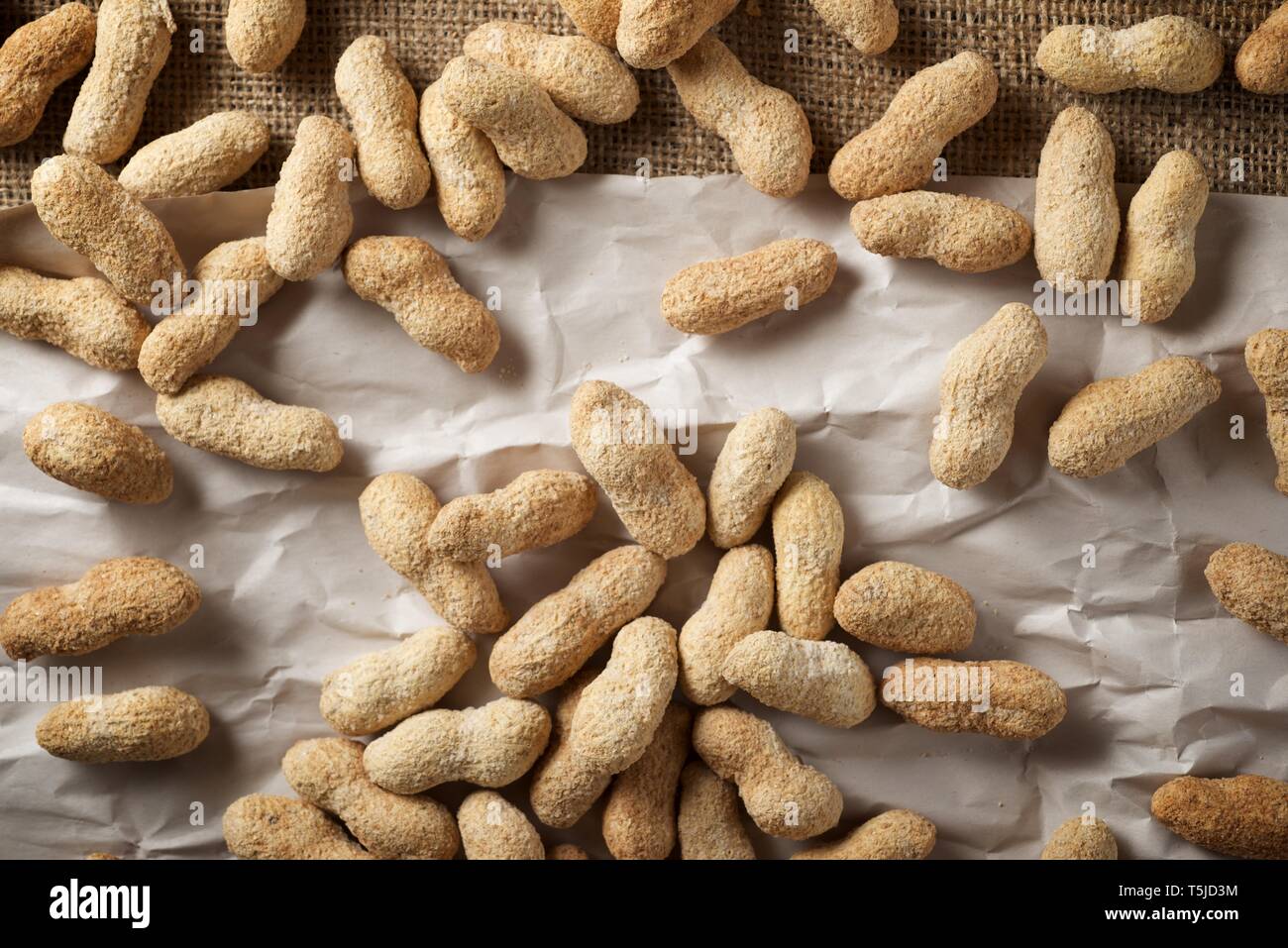 Peanuts with shell on a table Stock Photo - Alamy
