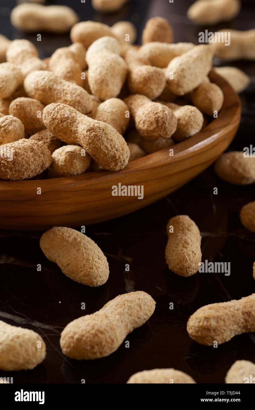 Peanuts with shell on a table Stock Photo - Alamy
