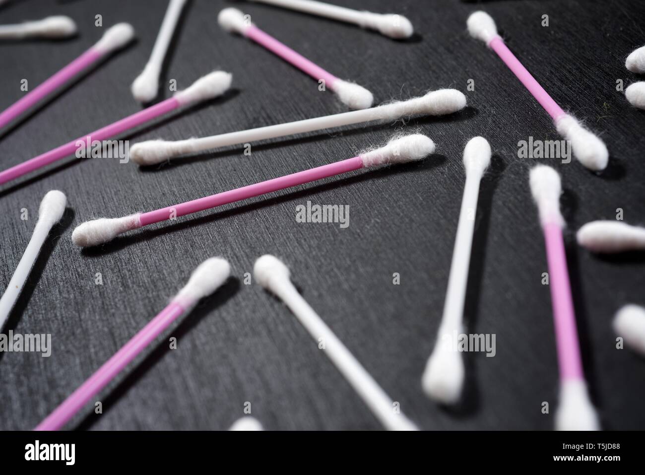 Ear swabs on a black table Stock Photo - Alamy