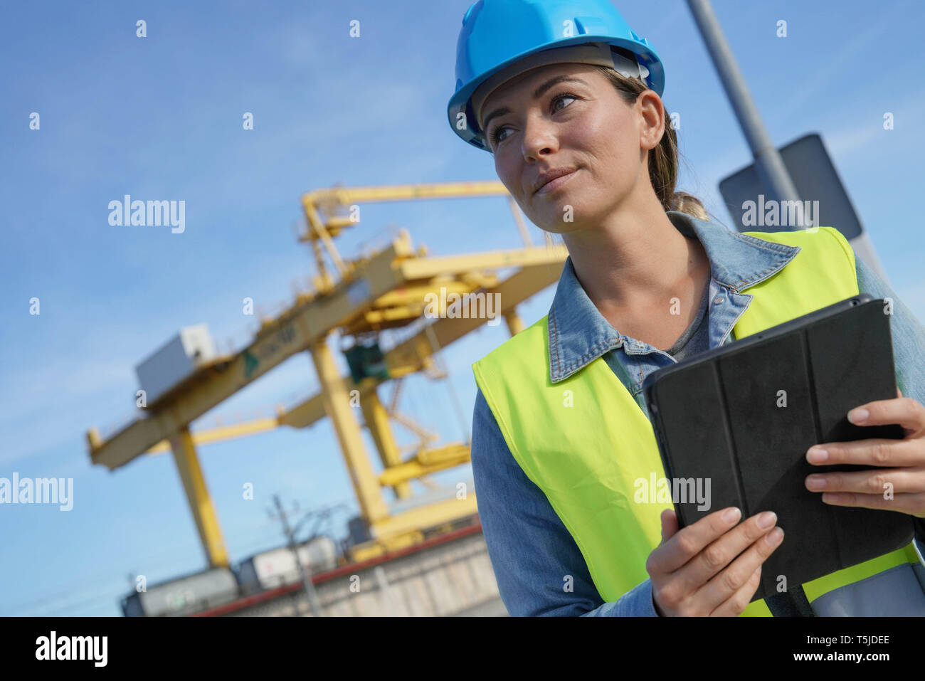 Woman on a building site checking looking out Stock Photo - Alamy