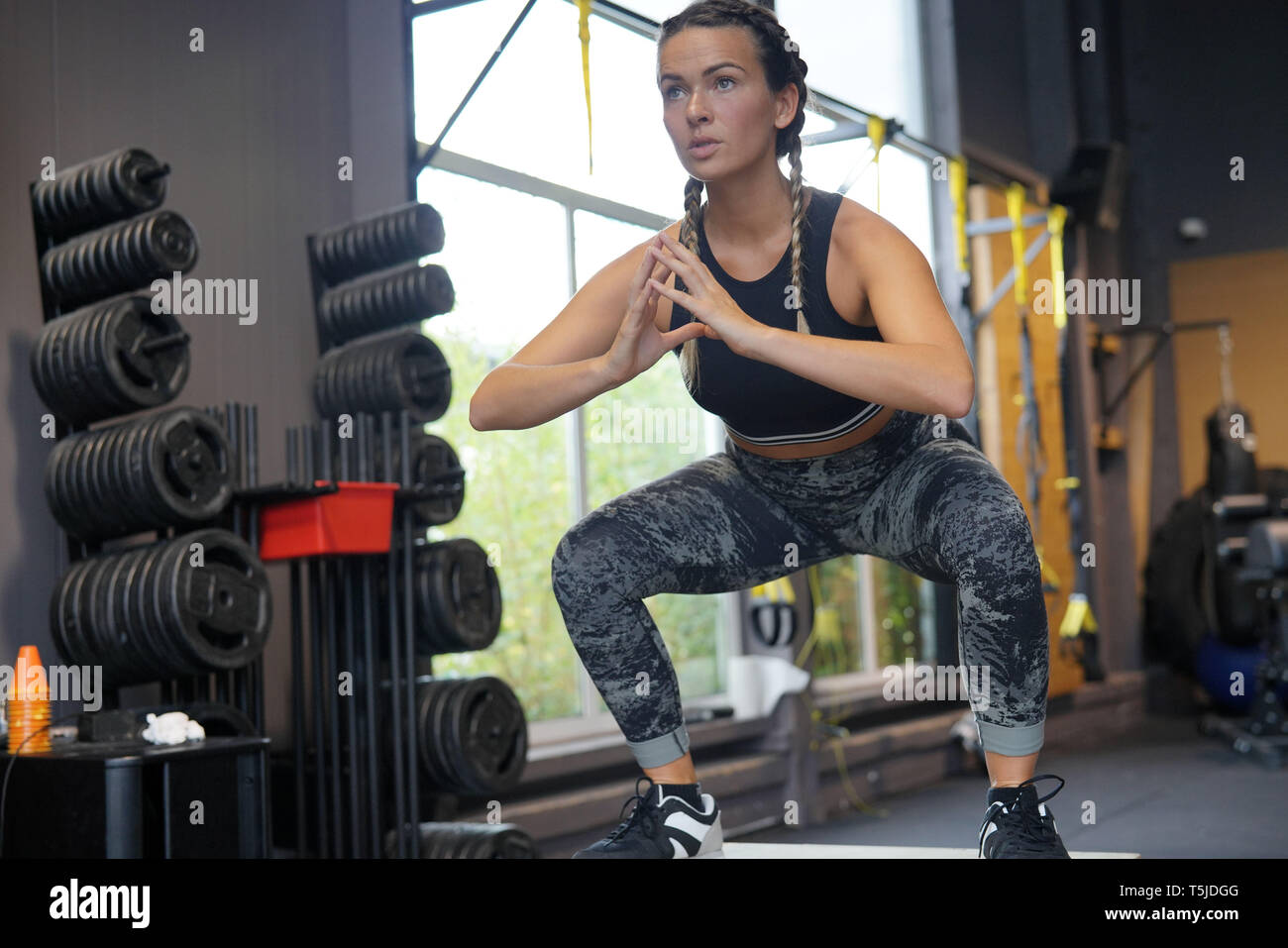 Adult brunette woman doing squats hi-res stock photography and images ...