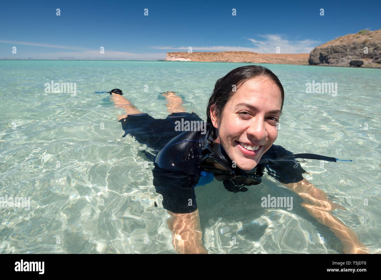 Woman cooling off in the water off Espiritu Santo Island, Baja ...